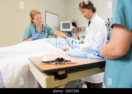 Doctor Stitching Male Patient's Wound Stock Photo - Alamy