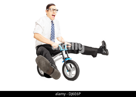 Crazy man riding a small bicycle. Funny bicycle rider. Comic man ride ...