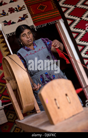 Spinning wool into yarn to be used in Navajo rug weaving. Southern ...