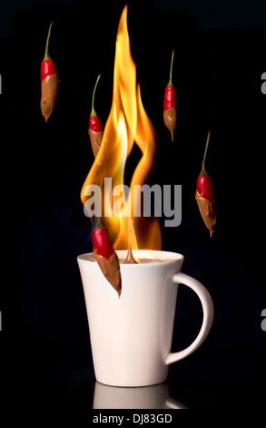 chilli and chocolate on a black background Stock Photo - Alamy