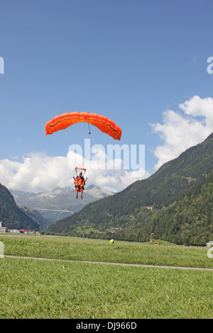 Skydiver under canopy is approaching the landing area. Hopefully she is ...