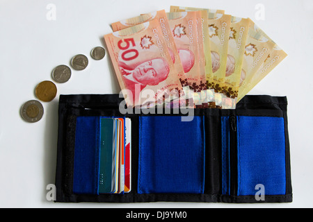 Many canadian dollar bills and spare change spread and filling the ...