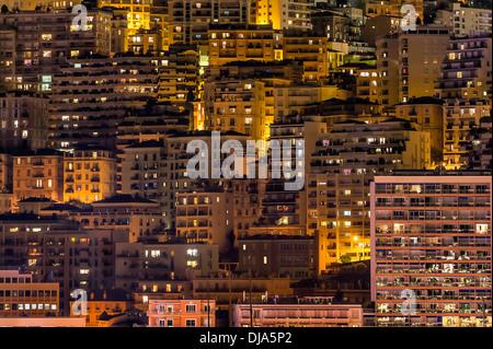 Dense cluster of city buildings at night Stock Photo - Alamy
