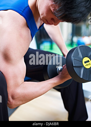 Chinese man working out with dumbbell on black background Stock Photo ...