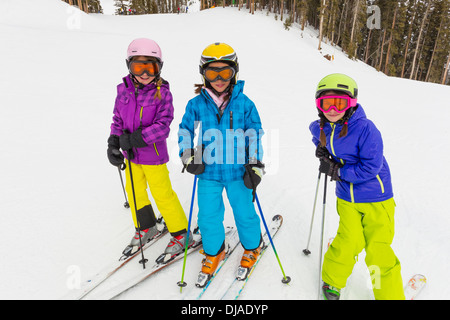 Children skiing on a snowy slope, showcasing winter sports in action ...