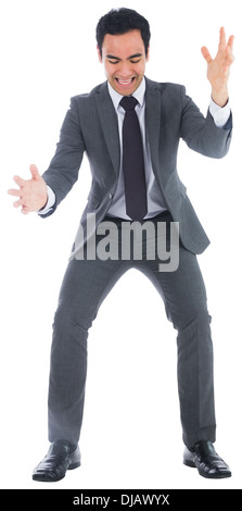 Young businessman screaming and scared with his arms up (above view ...