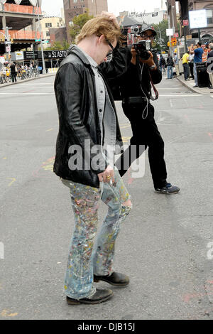 Macaulay Culkin wearing paint covered jeans, keeps his face hidden as ...