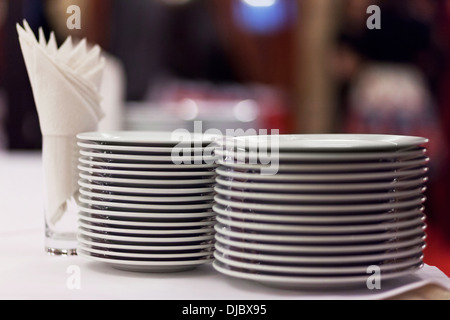 A stack of empty plates and napkins in a restaurant on a table Stock ...