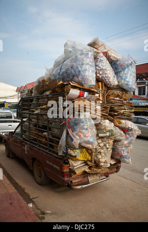 Very overloaded pickup truck in Thailand, carrying it's cargo of waste ...