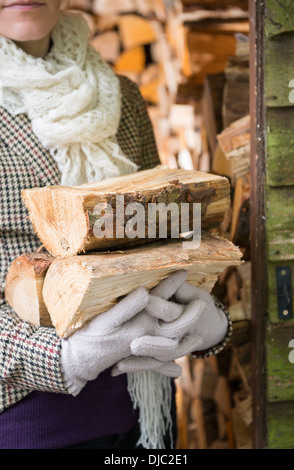 A woman collecting logs for a fire Stock Photo - Alamy