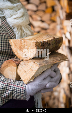 A woman collecting logs for a fire Stock Photo - Alamy