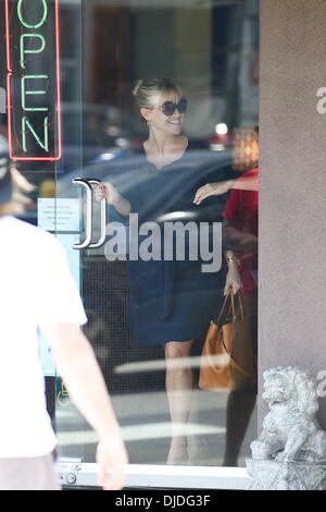 Showing off her baby bump as she awaits the arrival of her first child ...