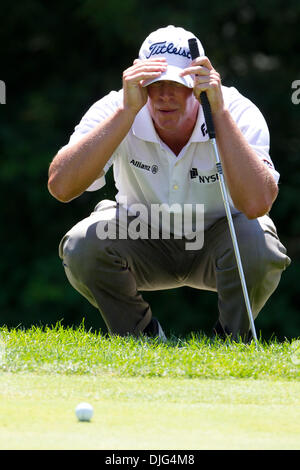Steve Stricker lines up a putt on the 18th green during the first round ...