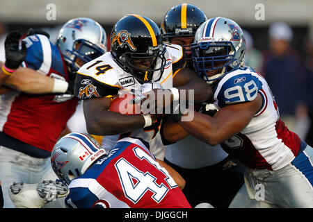 Hamilton Tiger-Cats running back Ante Litre (34) and Montreal Alouettes ...