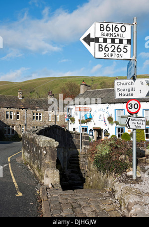 Old fashioned road signs at village cross roads and church, Wiveton ...