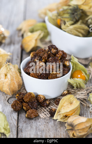 Dried Physalis in a small bowl on vintage wooden background Stock Photo ...