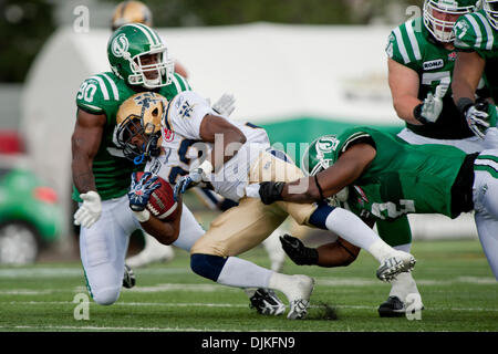 Winnipeg Blue Bombers running back Brady Oliveira, top right, is tackled by Saskatchewan ...