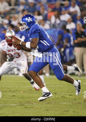 Kentucky quarterback Morgan Newton (12) attempts to break the tackle of ...