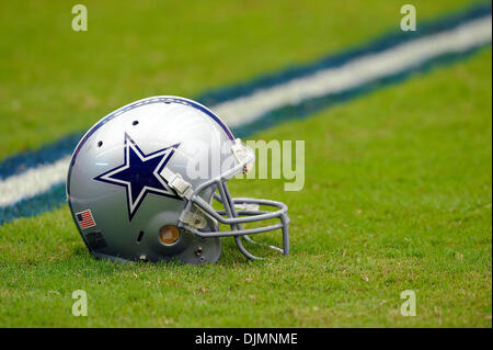 A Dallas Cowboys helmet rests on a Gatorade cooler during an NFL ...