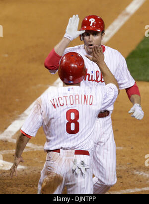 Philadelphia Phillies' Chase Utley, top, catches Atlanta Braves' Andruw ...