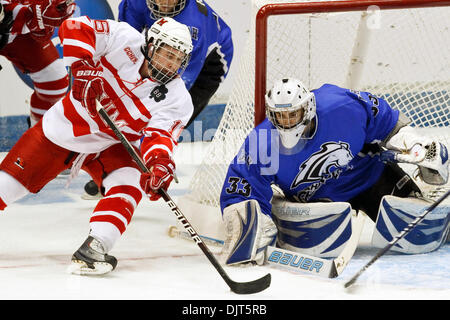 Miami left winger Curtis Mckenzie (16) tries to shoot the puck past ...