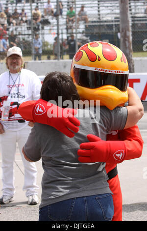 Firehawk the Long Beach Grand Prix mascot posses with a fan during the ...