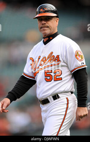 Baltimore Orioles third base coach Tim Trebelhorn congratulates Miguel ...