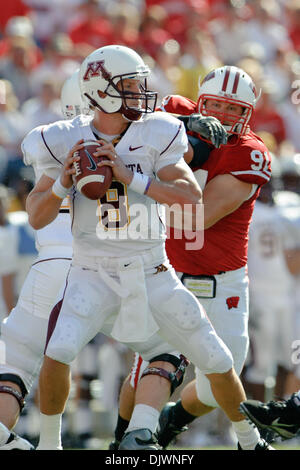 Minnesota quarterback Adam Weber drops back to pass during the first ...