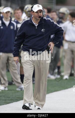 Akron head coach Rob Ianello leads center Adam Bice (65) and guard Zac ...