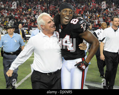 Georgia head coach Mike White talks to his players from the bench ...