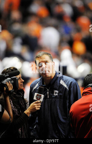 Connecticut football coach Randy Edsall, right in green suit and yellow ...