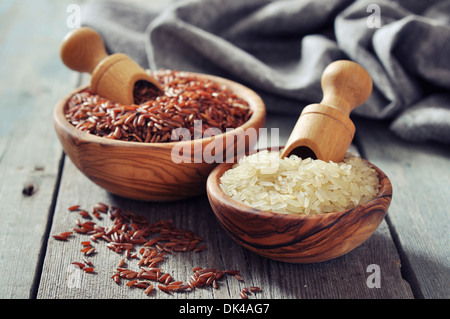 Different kinds of rice in bowls on wooden background Stock Photo - Alamy