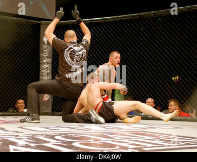 Referee in an MMA cage fight talks to fighters before the match begins ...