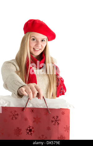 Pretty young woman with Christmas gift box sitting on sofa at home ...