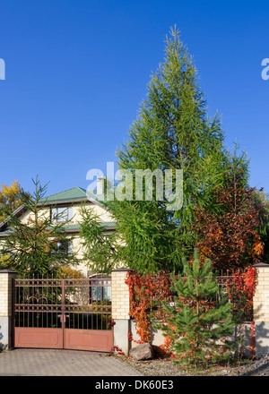 A beautiful shot of trees behind a brick fence Stock Photo - Alamy