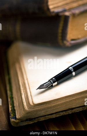 open book and a old fountain pen on blue background Stock Photo - Alamy