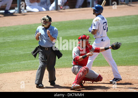 A home plate umpire makes a strike call during a high school baseball ...