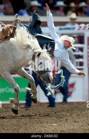 A cowboy gets bucked off a saddle bronc and loses his boot as he ...