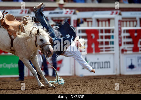 A cowboy gets bucked off a saddle bronc and loses his boot as he ...