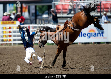 A cowboy gets bucked off a saddle bronc and loses his boot as he Stock ...
