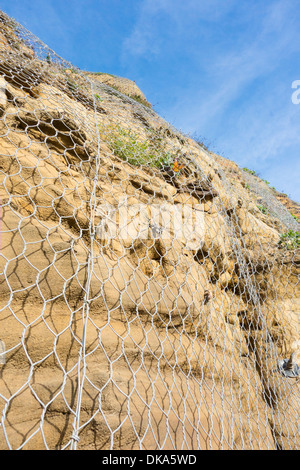 Wire mesh netting used to stabilize the sandstone cliffs against ...