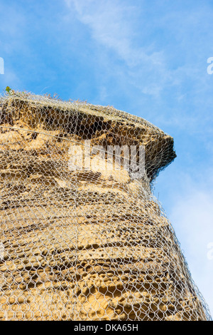 Wire mesh netting used to stabilize the sandstone cliffs against ...