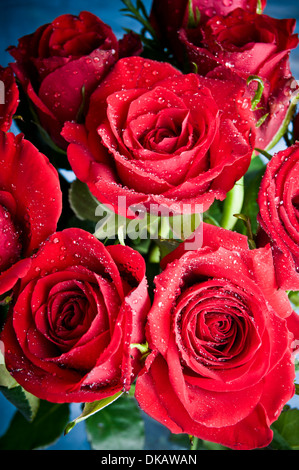 Red roses flower bouquet on white stone table. Top view with copy space ...