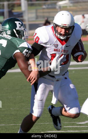 Ball State quarterback Keith Wenning (10) looks to pass as he is chased ...