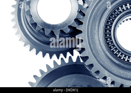 Metal cog gears joining together Stock Photo - Alamy