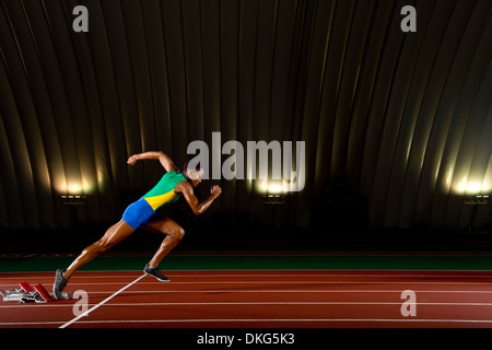 Female sprinter in starting blocks Stock Photo - Alamy