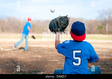 Two boys playing baseball catch and talking Stock Photo - Alamy
