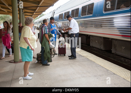 Conductor checking tickets of passengers in a train Stock Photo - Alamy