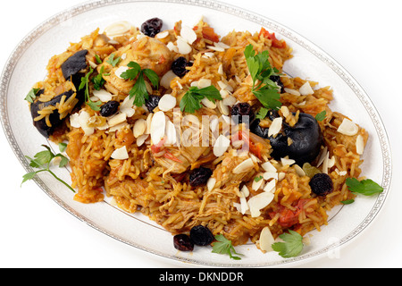 An authentic Saudi chicken kabsa (known in Qatar as majbous), garnished ...