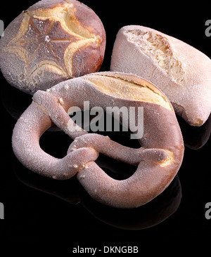 frozen german lye rolls and bread roll in light back Stock Photo - Alamy